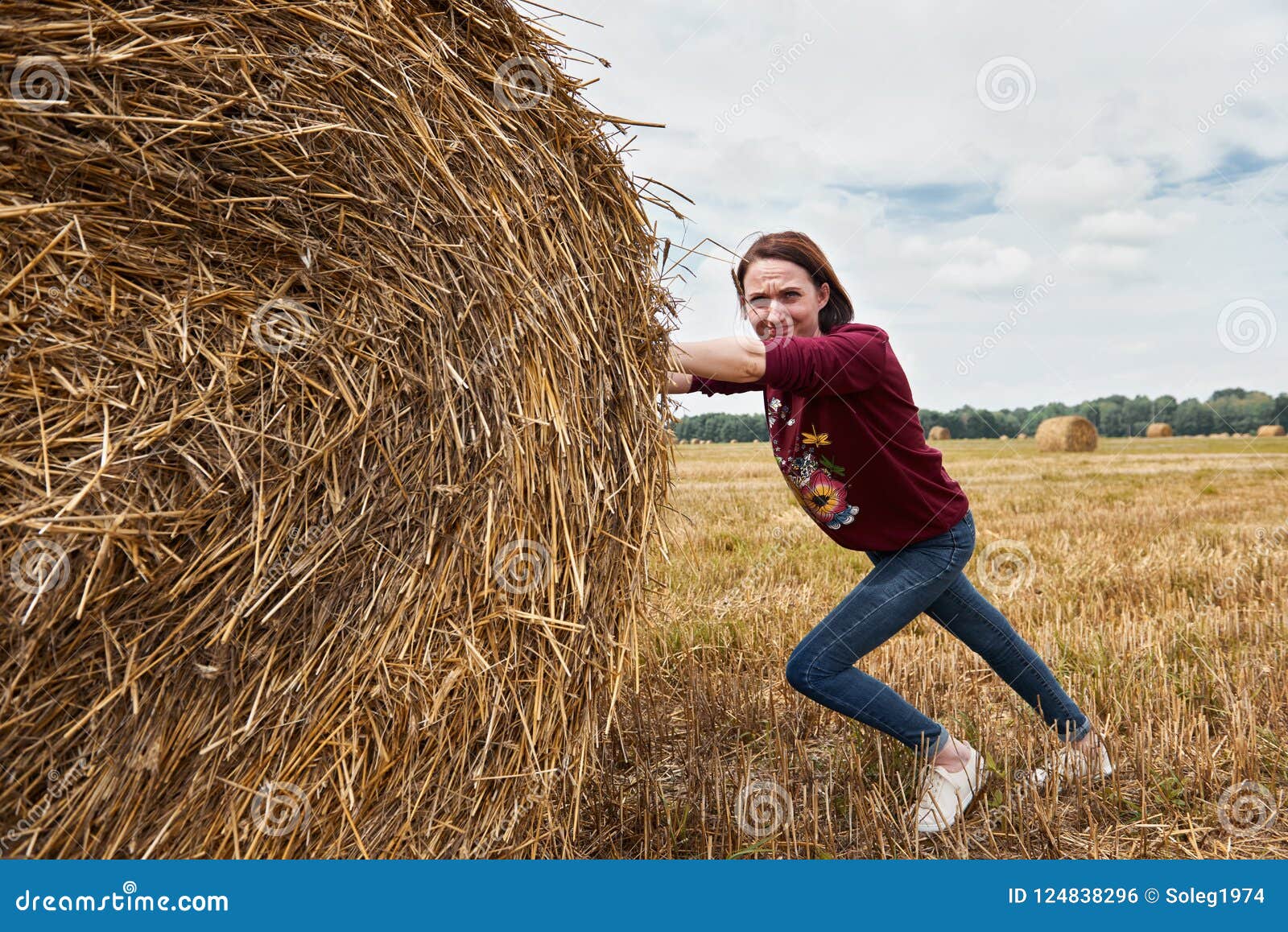 Young Girl Having Fun in the Field, Pushes the Haystack Stock Photo ...