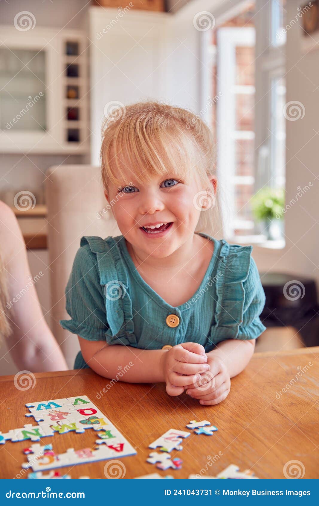 Young Girl Having Fun Sitting at Table at Home Doing Jigsaw Puzzle ...