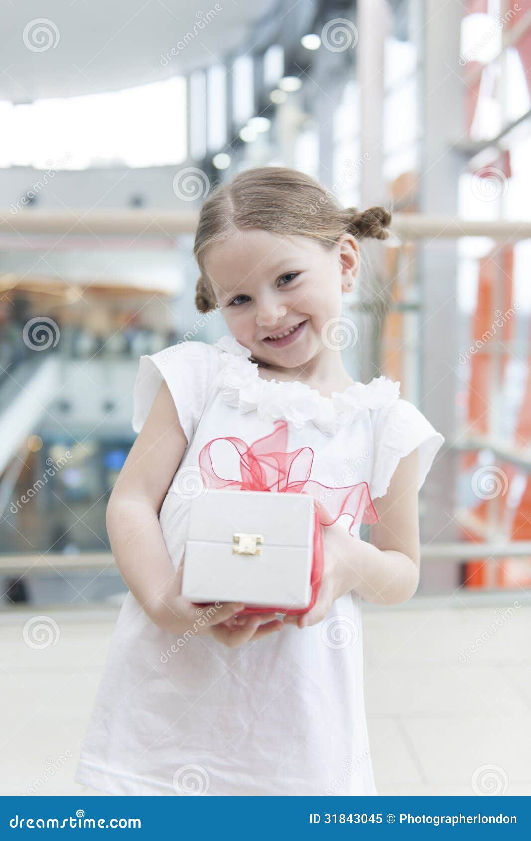 Young Girl Holding Present Wrapped in Big Red Bow Stock Image - Image ...
