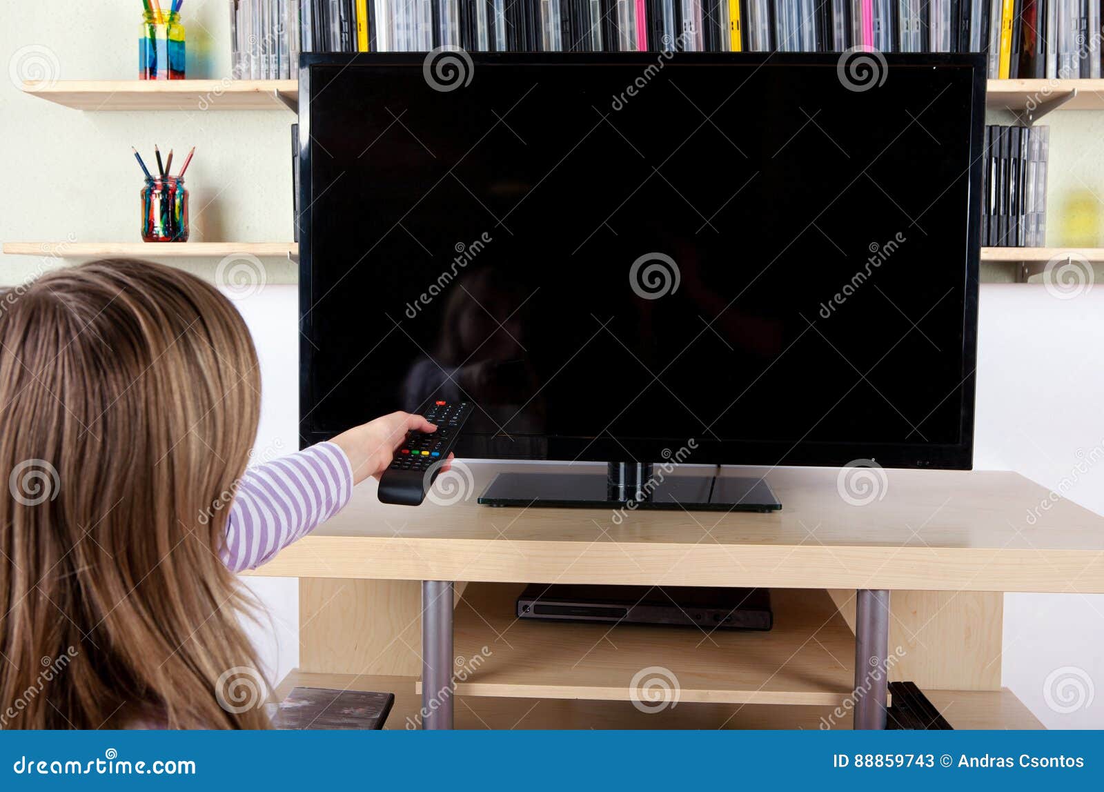 Young Girl Holding Remote Control in Front of the TV Stock Image ...