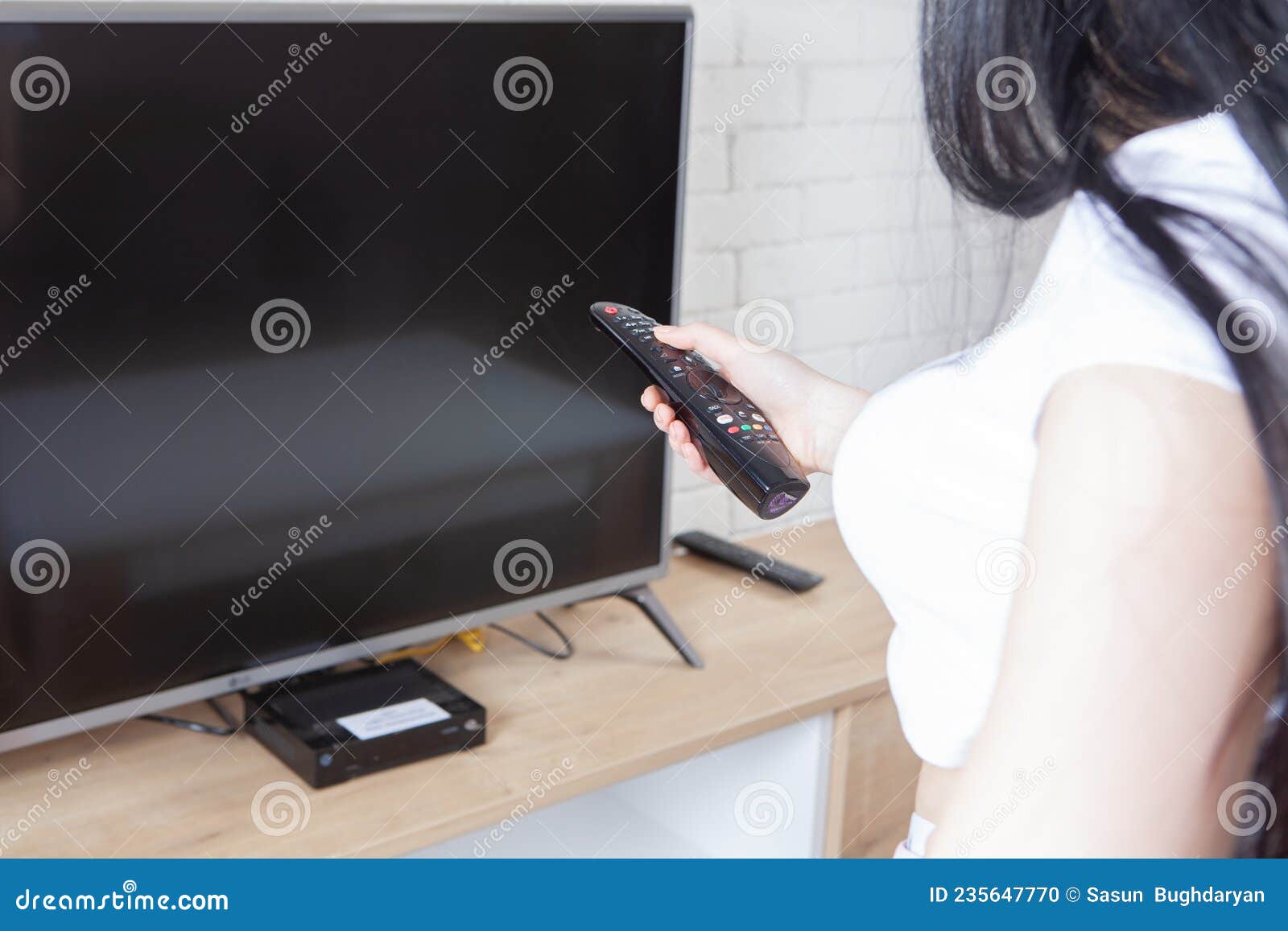 Young Girl Holding a Tv Remote Stock Photo - Image of relax, lifestyle ...