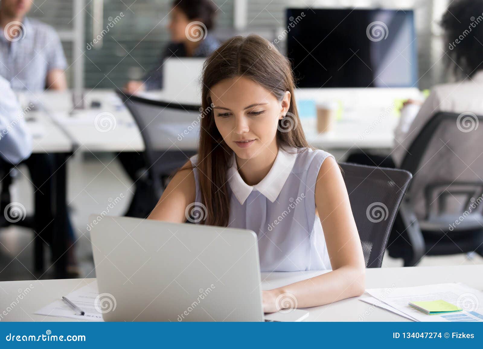 Young Girl, Intern Using Laptop at Workplace in Office Stock Photo ...