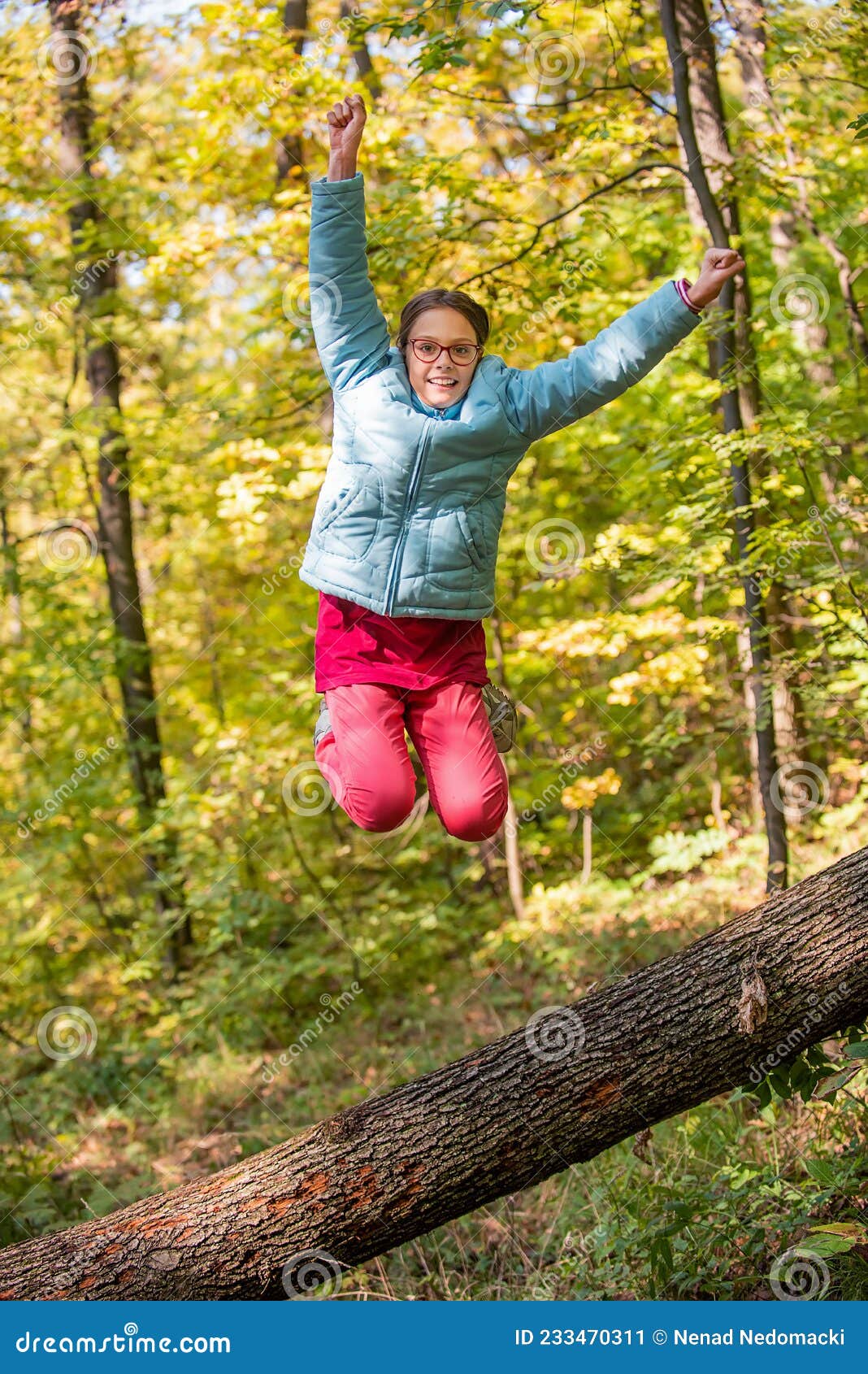 Young Girl Jumping on Fallen Down Tree Trunk and Catching Balance Stock ...