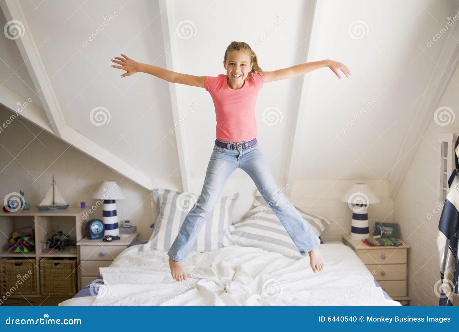 Young Girl Jumping on Her Bed Stock Photo - Image of raised, happy: 6440540