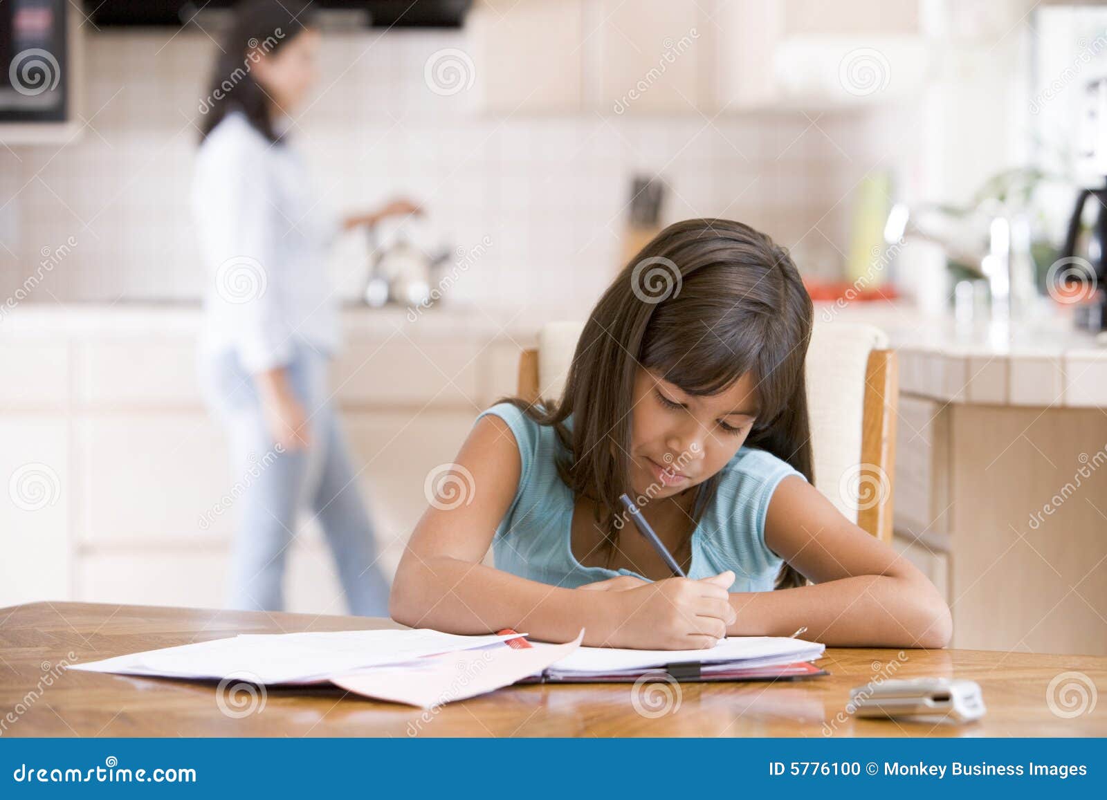 Young Girl in Kitchen Doing Homework with Woman in Stock Photo - Image ...