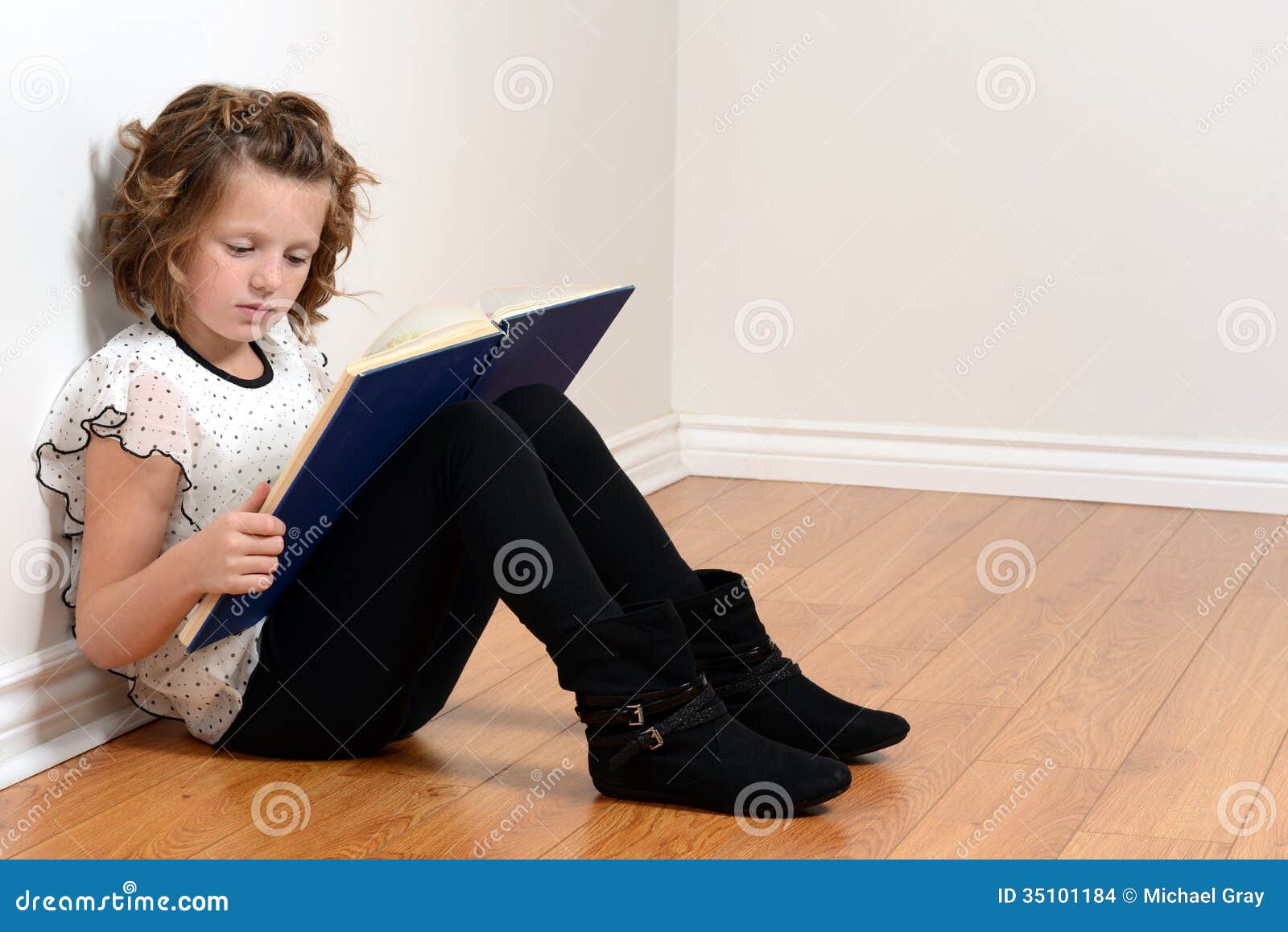 Young Girl Leaning on Wall Reading Book Stock Photo - Image of book ...