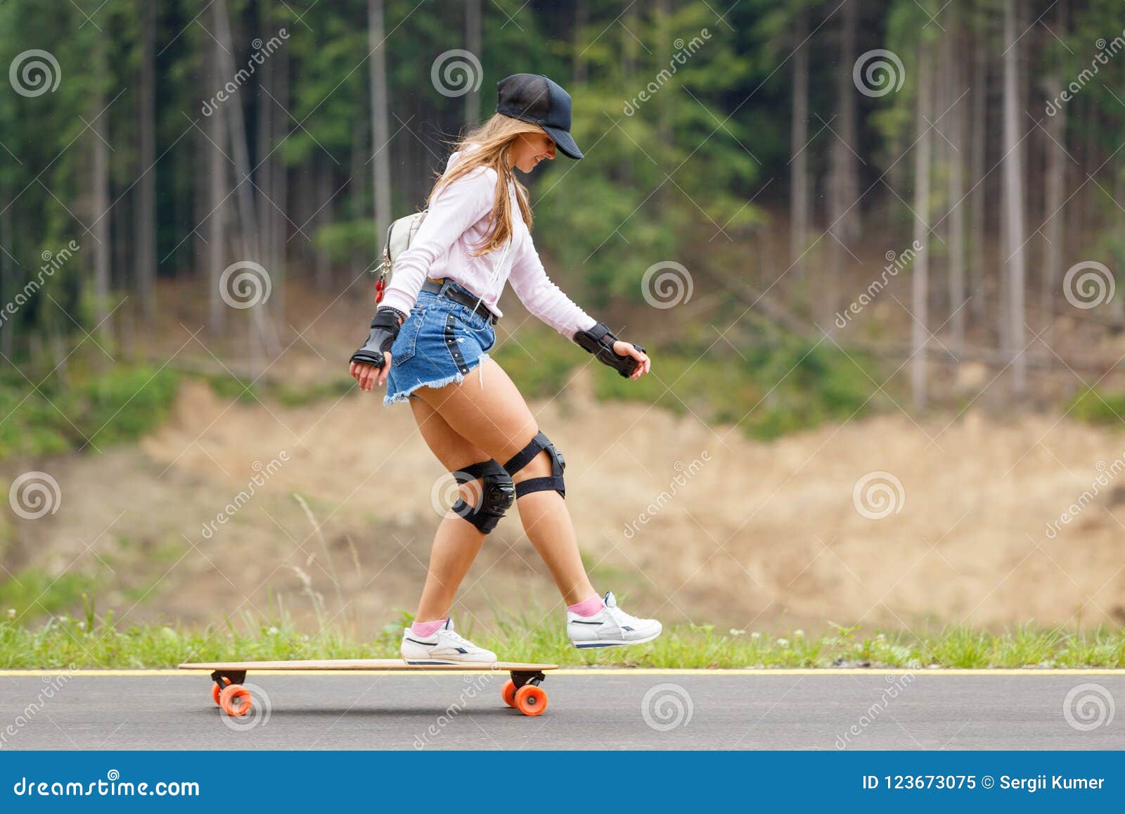 Young Girl Longboarding Downhill on Hillside Road Stock Image - Image ...