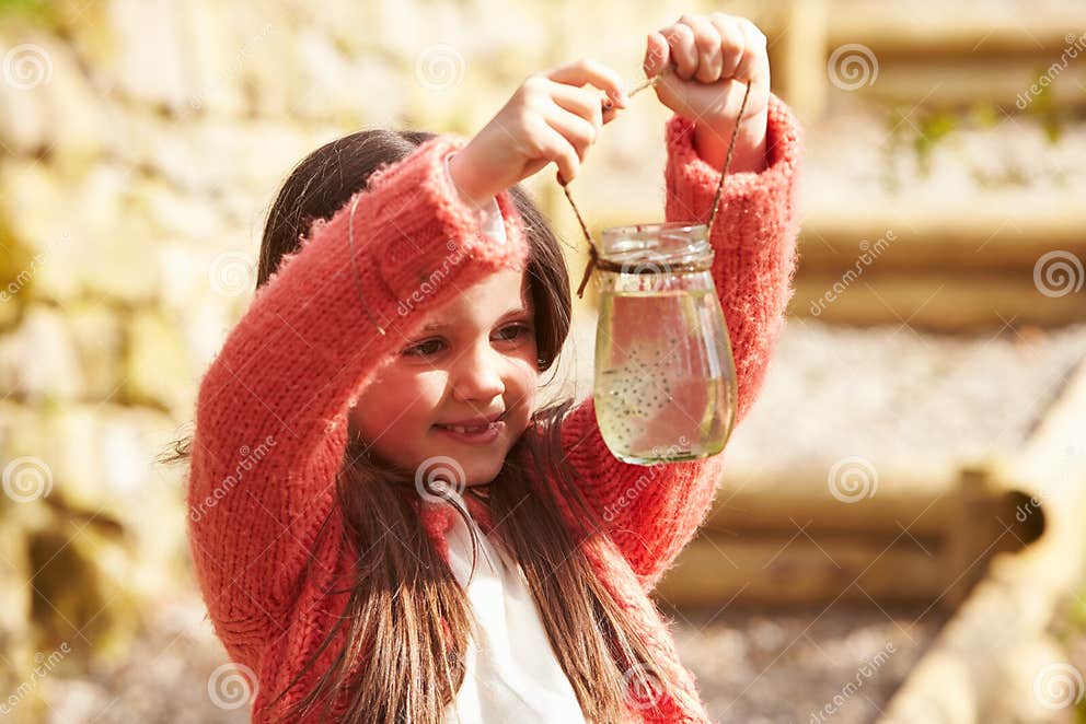 Young Girl Looking at Frogspawn in Jar Stock Photo - Image of studying ...