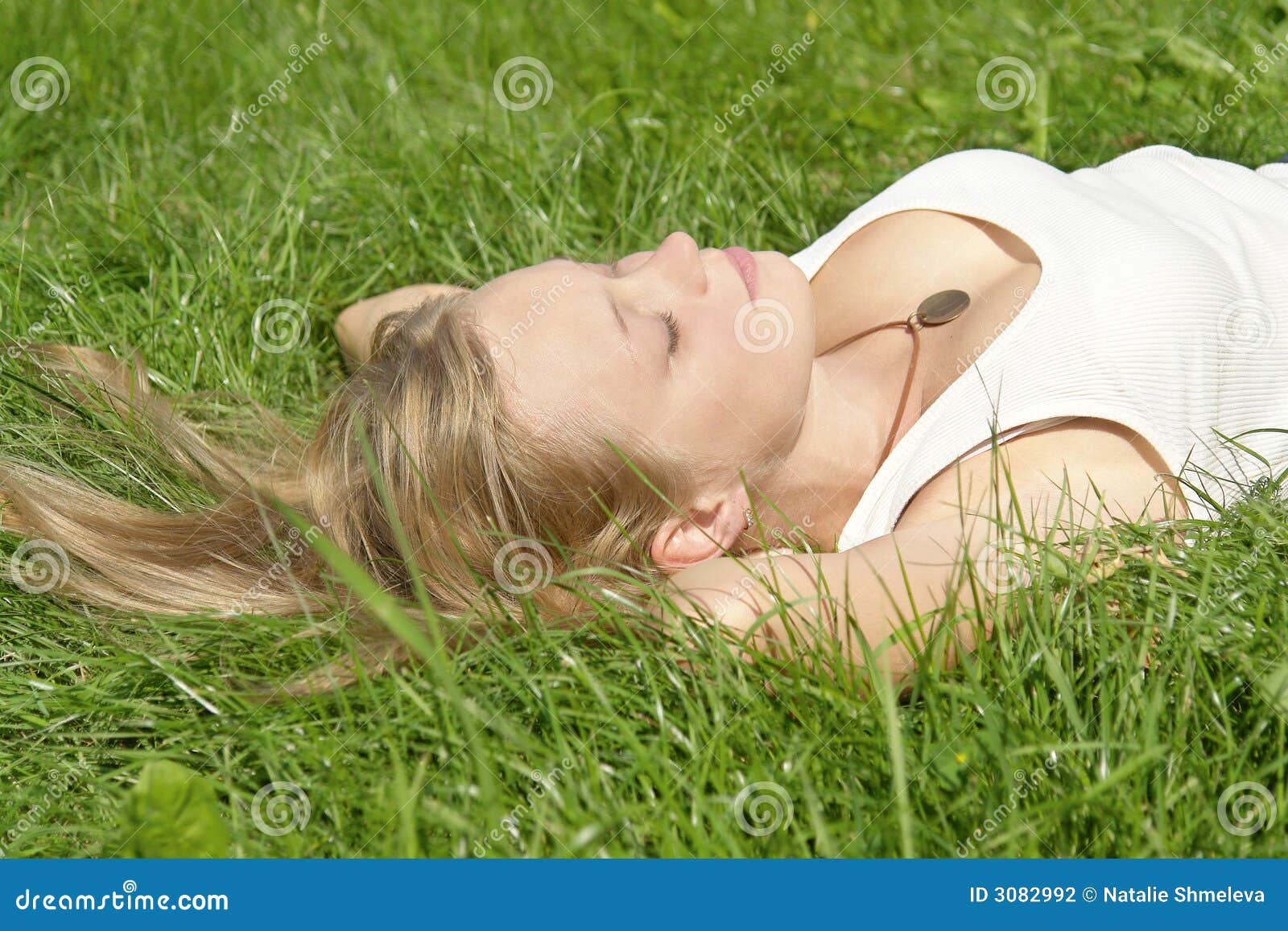 Young Girl Lying on the Grass Stock Photo - Image of heat, hands: 3082992