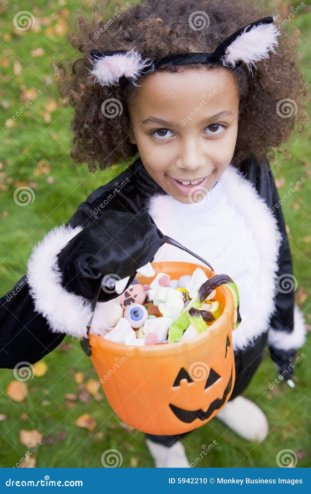 Young Girl Outdoors in Cat Costume Holding Candy Stock Photo - Image of ...