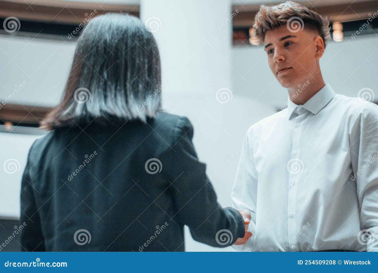 Young Girl Performs a Handshake with Her Client in Her Office Stock ...