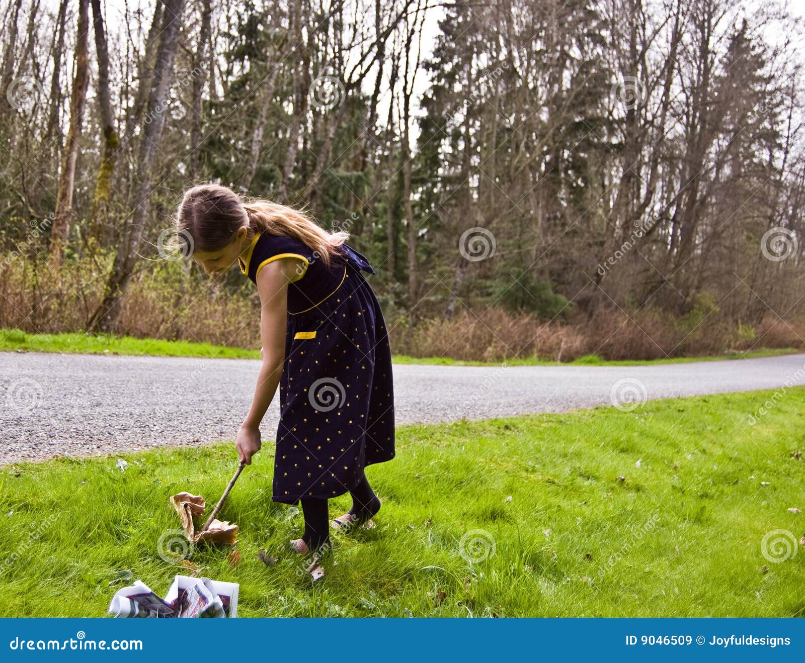 Young Girl Picking Up Litter with a Stick Stock Image - Image of ...