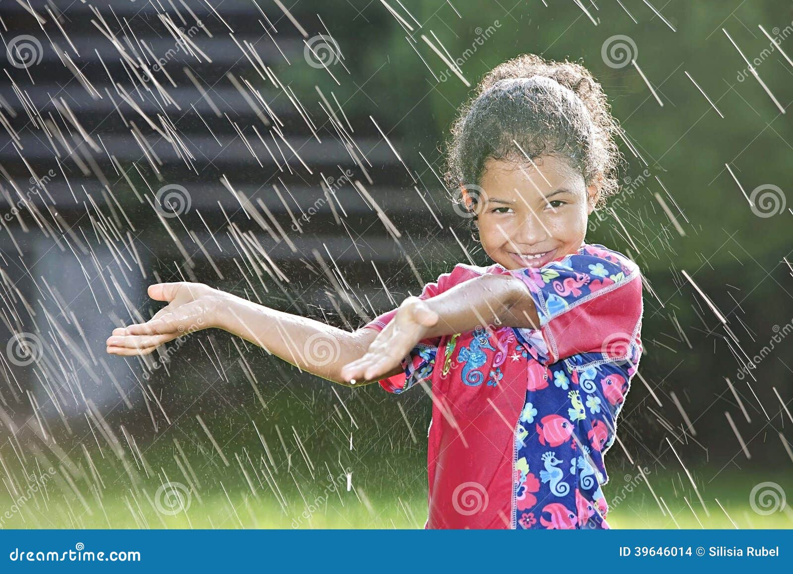 Young Girl Playing in the Rain Stock Photo - Image of girl, sprinkles ...