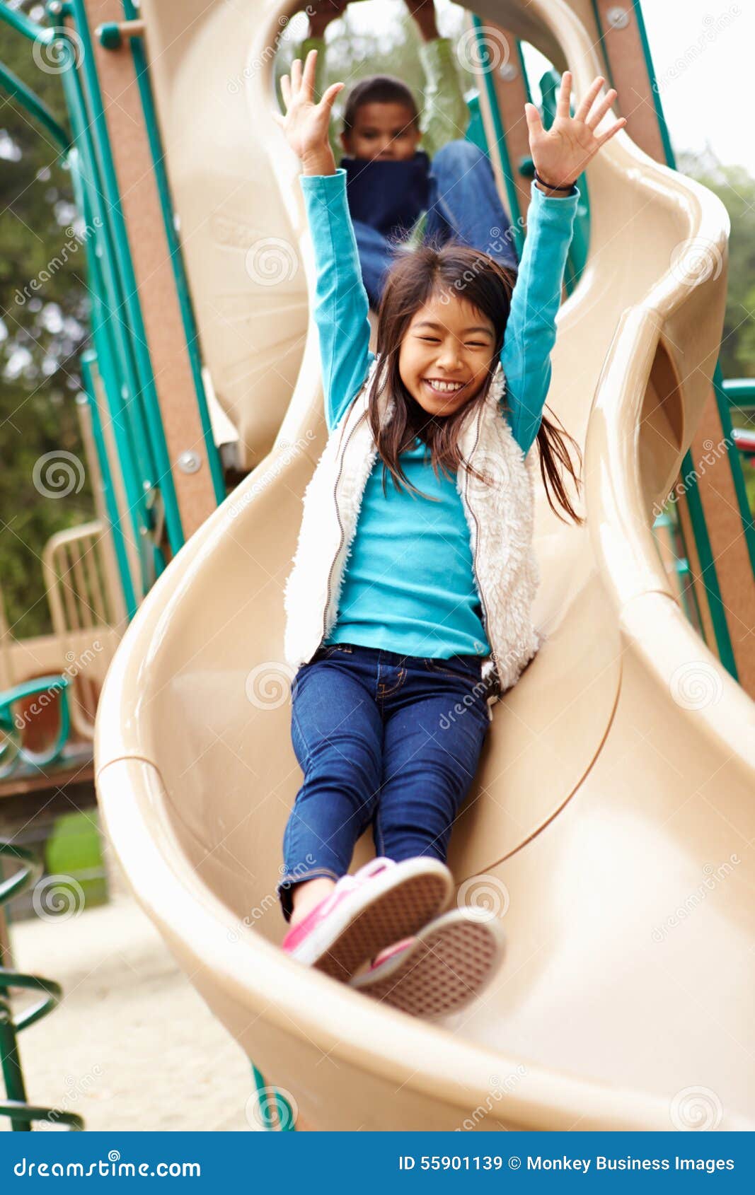 Young Girl Playing on Slide in Playground Stock Image - Image of ...