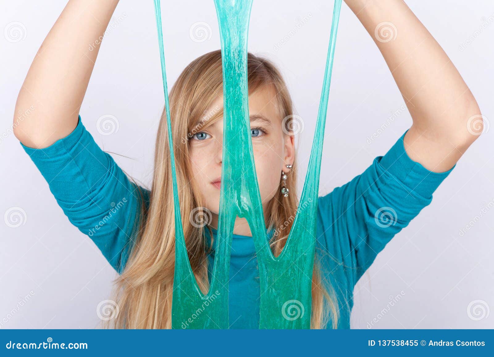 Young Girl Playing with Slime Holding it in Front of Her Face Stock ...