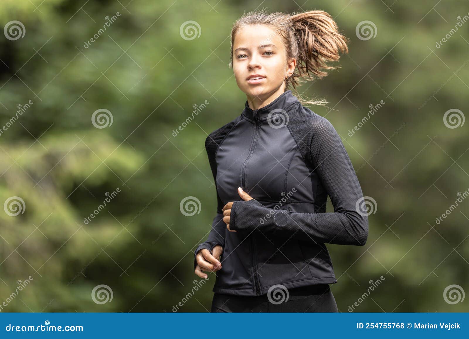 Young Girl with a Ponytail and Black Clothes is Jogging Outdoors Stock ...