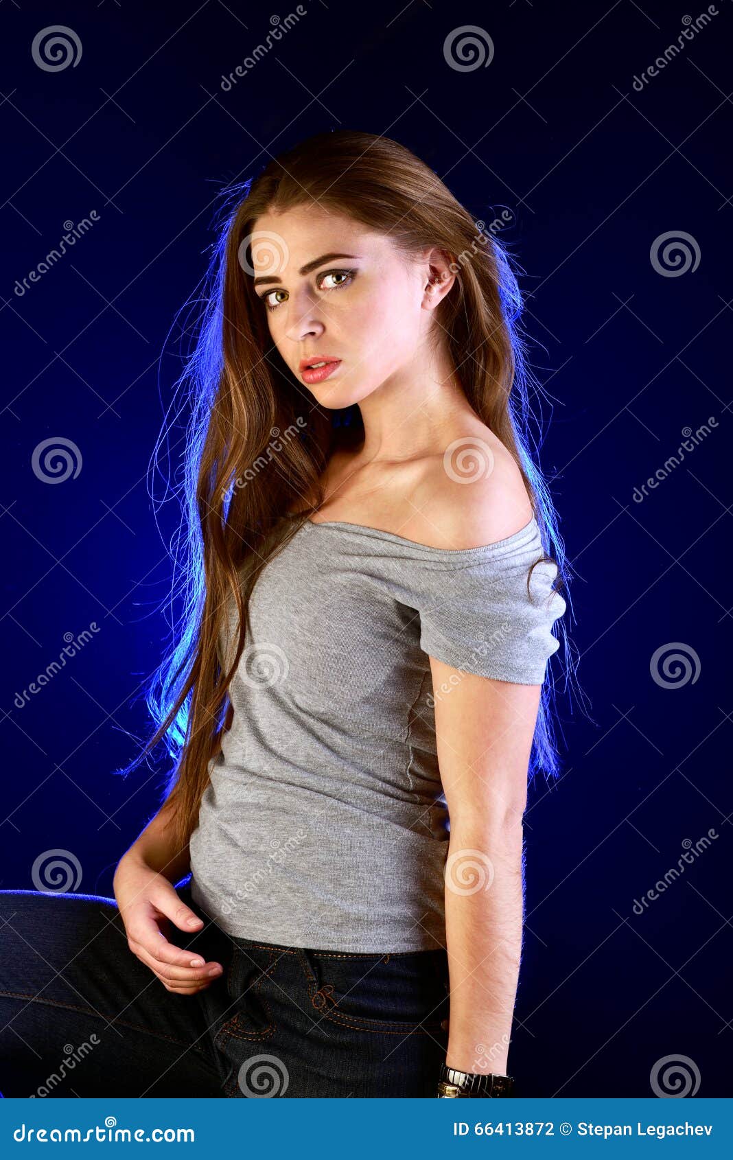 Young Girl Posing on Blue Backlight Background Stock Photo - Image of ...