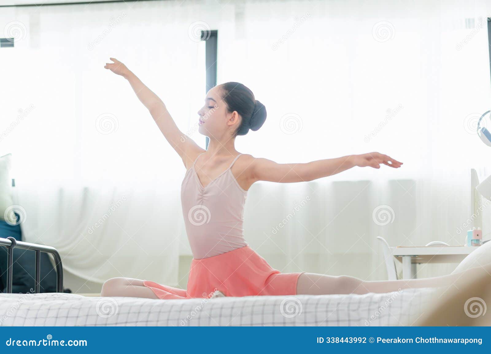 A Young Girl Practices Her Stretching Routine in Bedroom before Practicing Ballet, Young Dancer ...