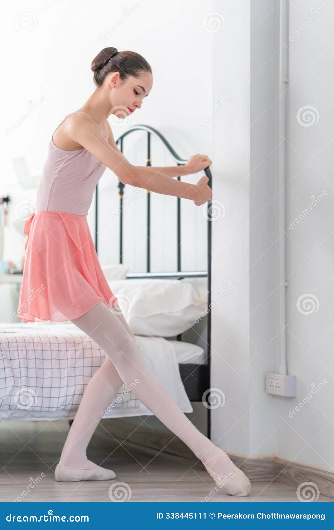 A Young Girl Practices Her Stretching Routine In Bedroom Before ...