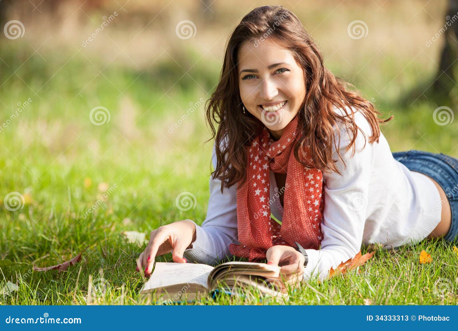 Young Girl Reading Book while Lying on Grass Stock Image - Image of ...