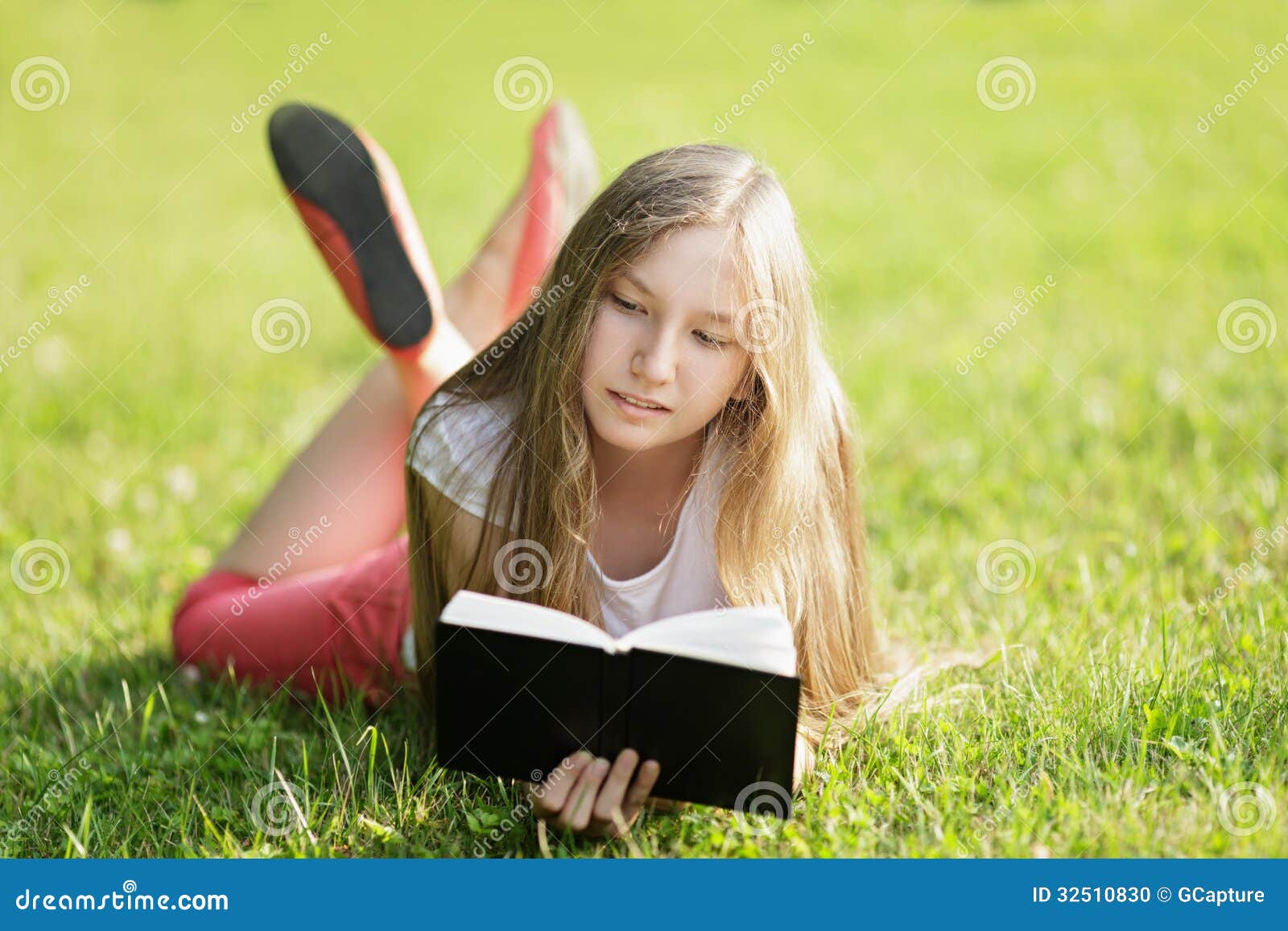 Young Girl Reading Book Lying on the Grass Stock Photo - Image of cute ...