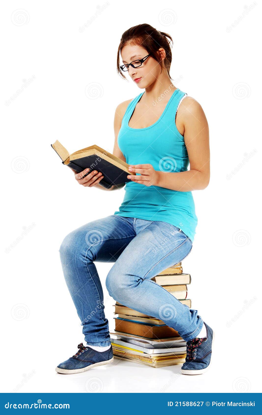 Young Girl Reading a Book Sitting on Books. Stock Image - Image of ...
