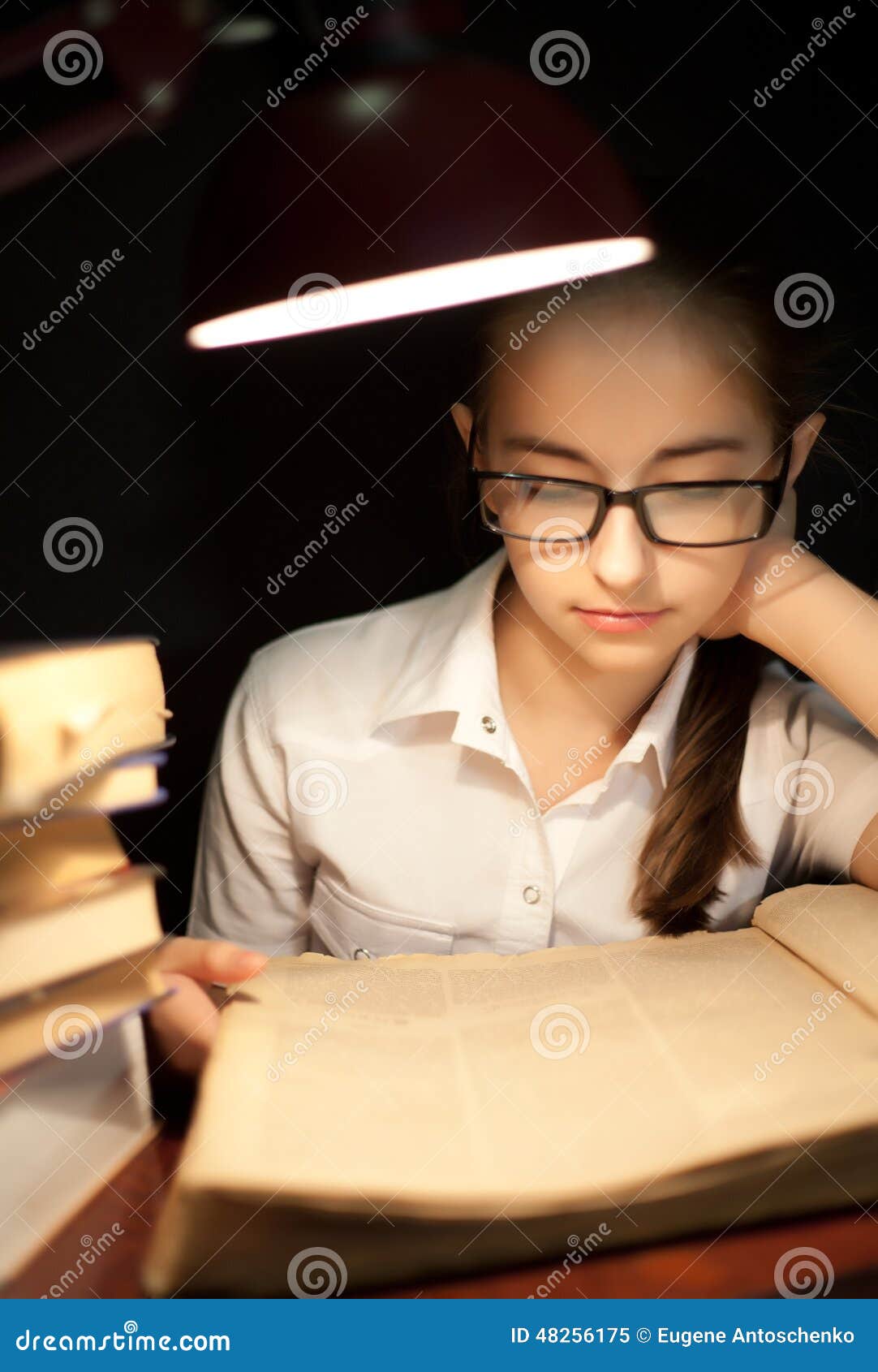 Young Girl Reading Book Under Lamp Stock Image - Image of light, desk ...