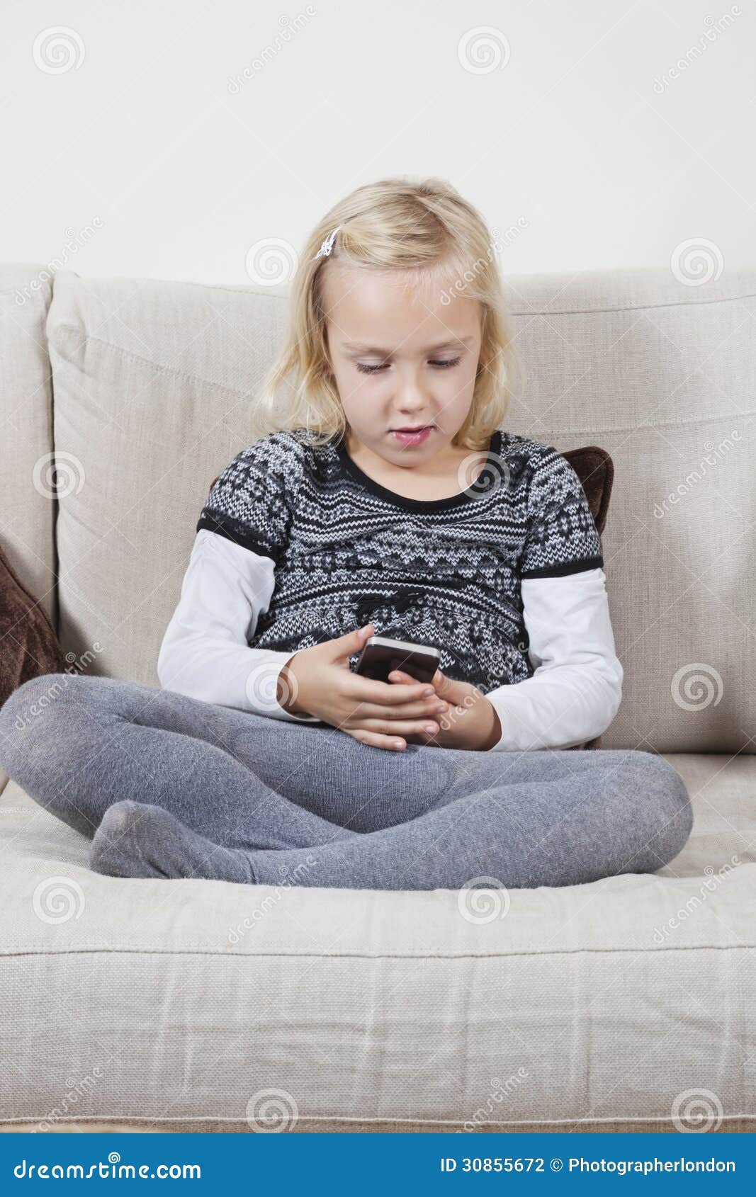 Young Girl Reading Text Message on Sofa Stock Photo - Image of ...
