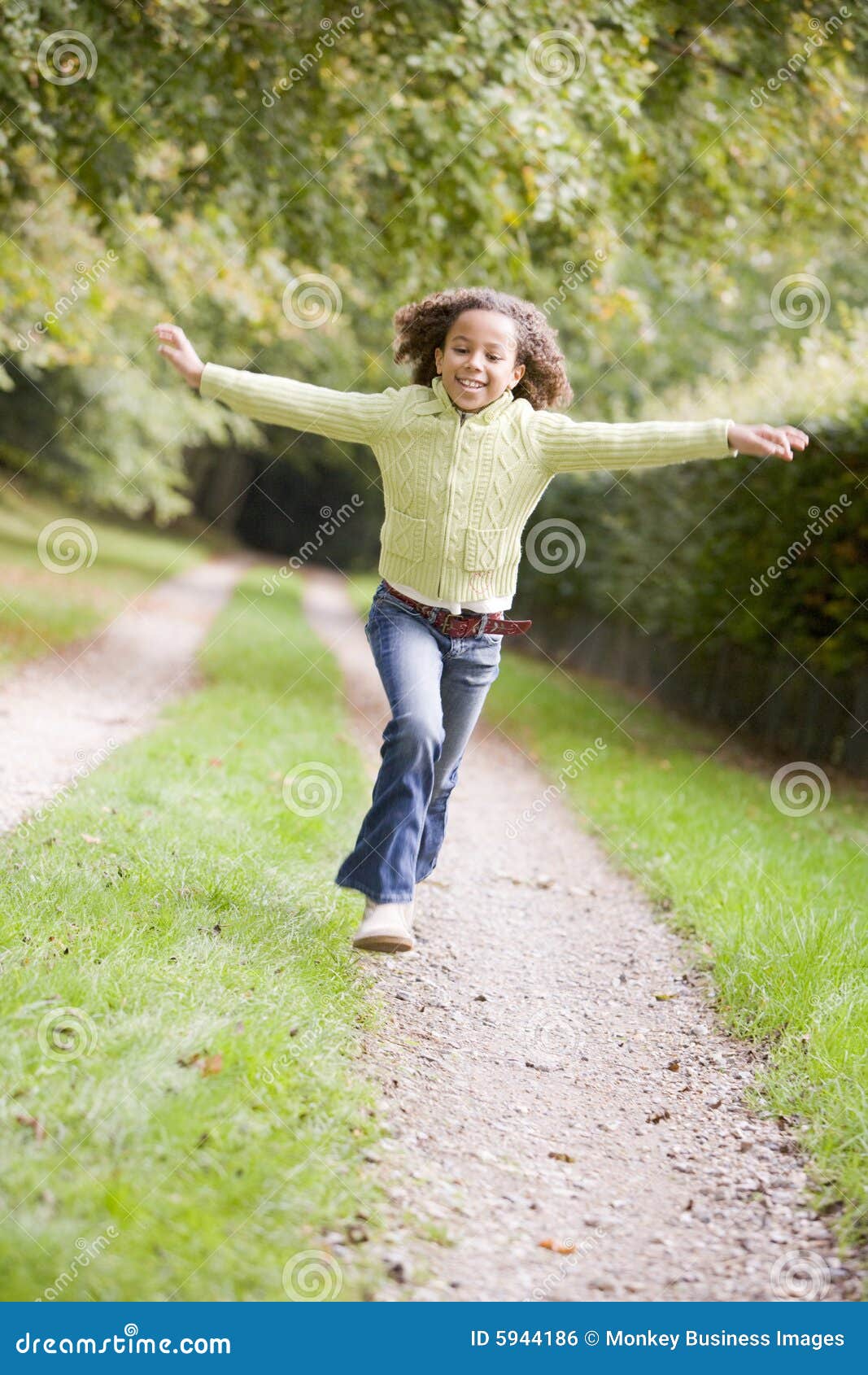Young Girl Running on a Path Outdoors Smiling Stock Photo - Image of ...