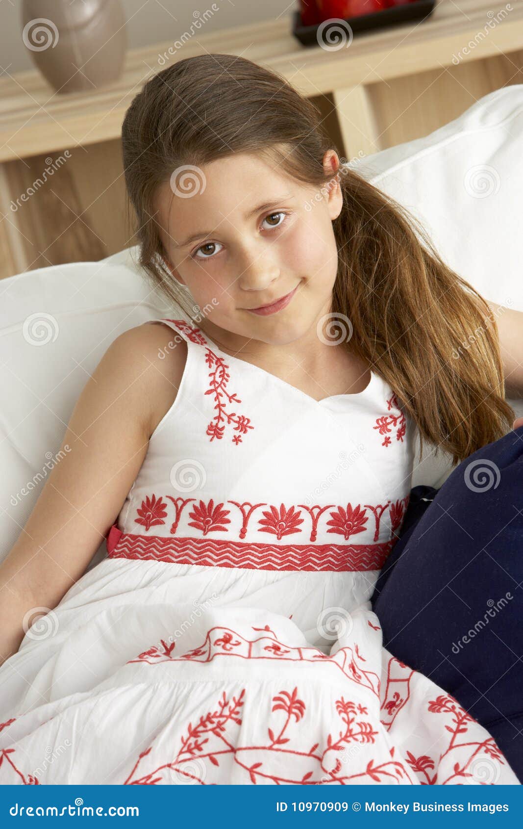 Young Girl Sat on Sofa at Home Stock Image - Image of relaxed, camera ...