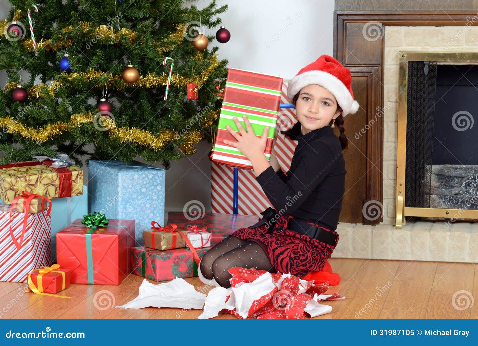Young Girl Shaking Christmas Gift Stock Image - Image of girl, cute ...