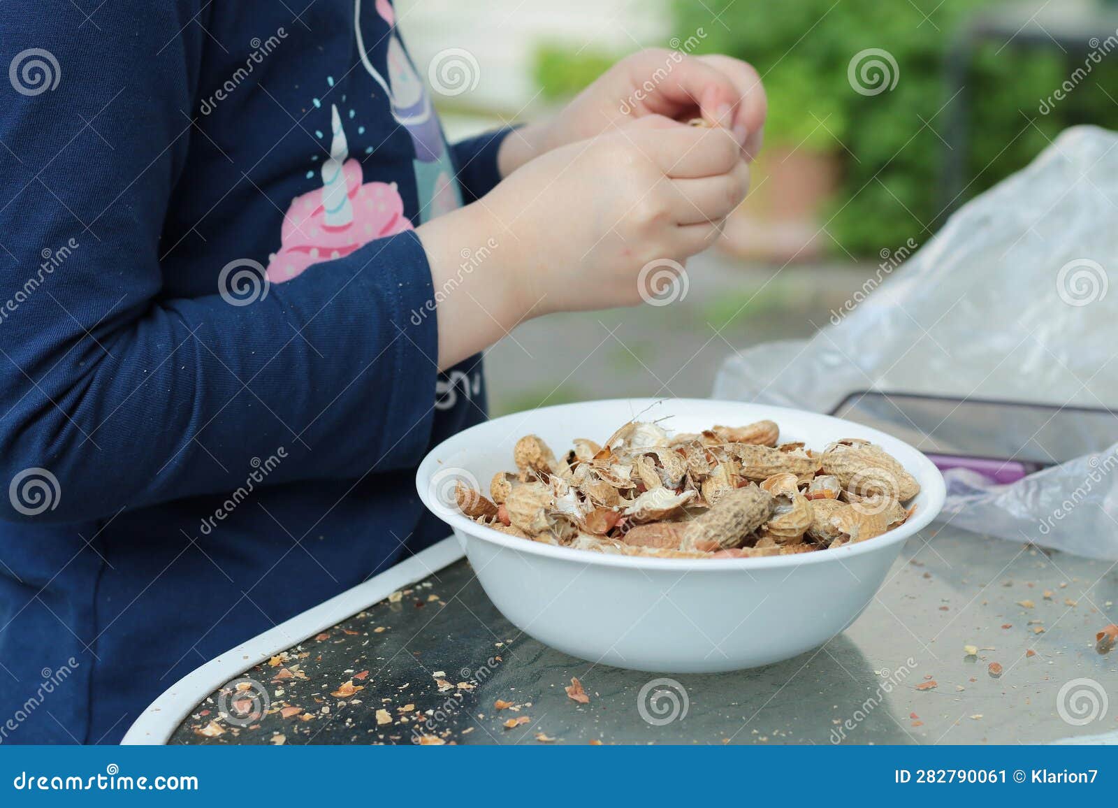 Young Girl Shelling Peanuts in the Backyard Stock Image - Image of ...