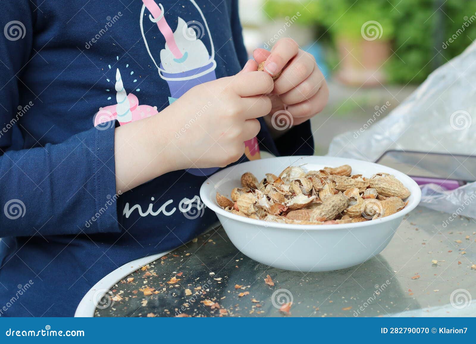 Young Girl Shelling Peanuts in the Backyard Stock Photo - Image of ...