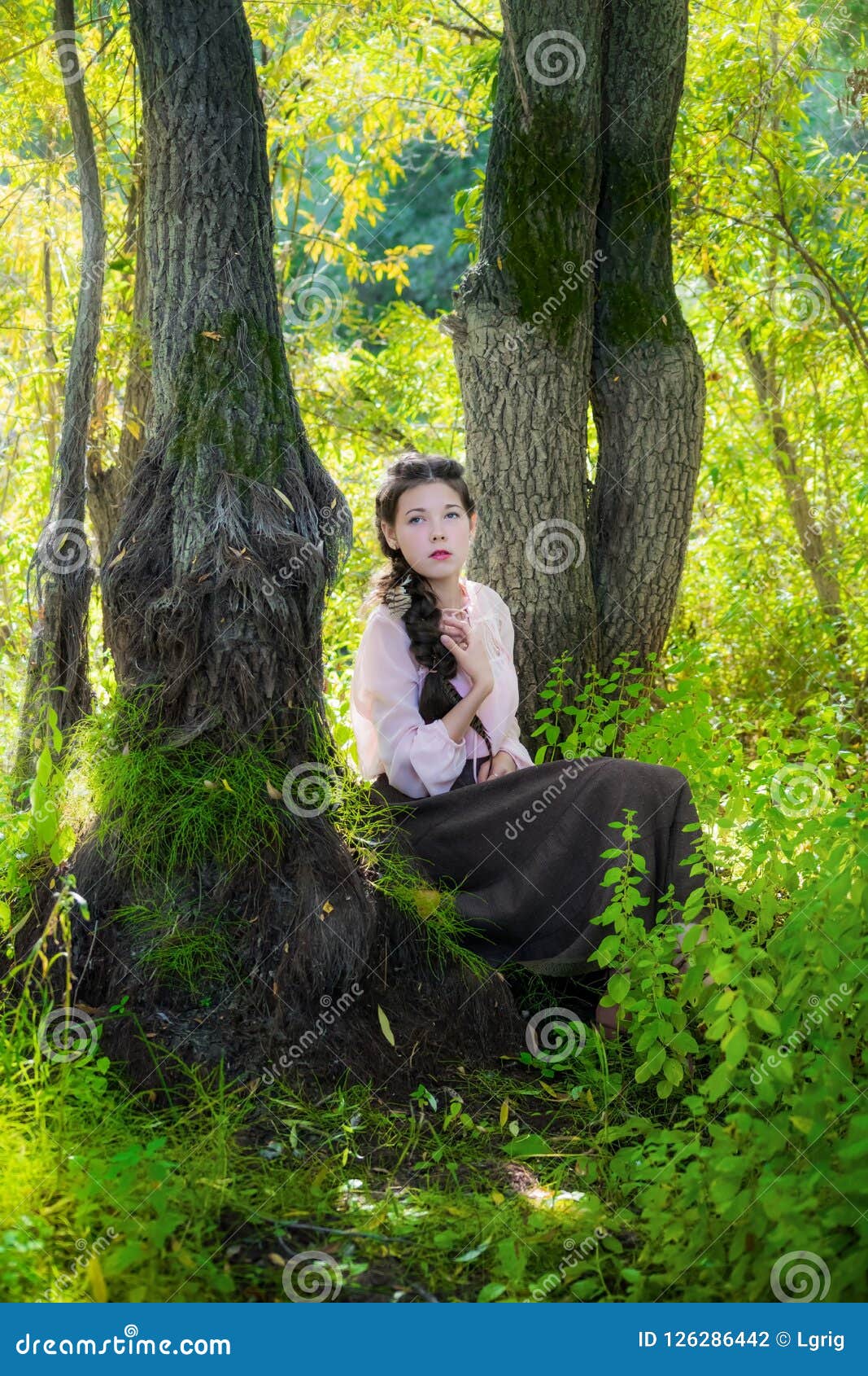 Young Girl Sits Under a Tree in the Forest. Stock Photo - Image of hair ...