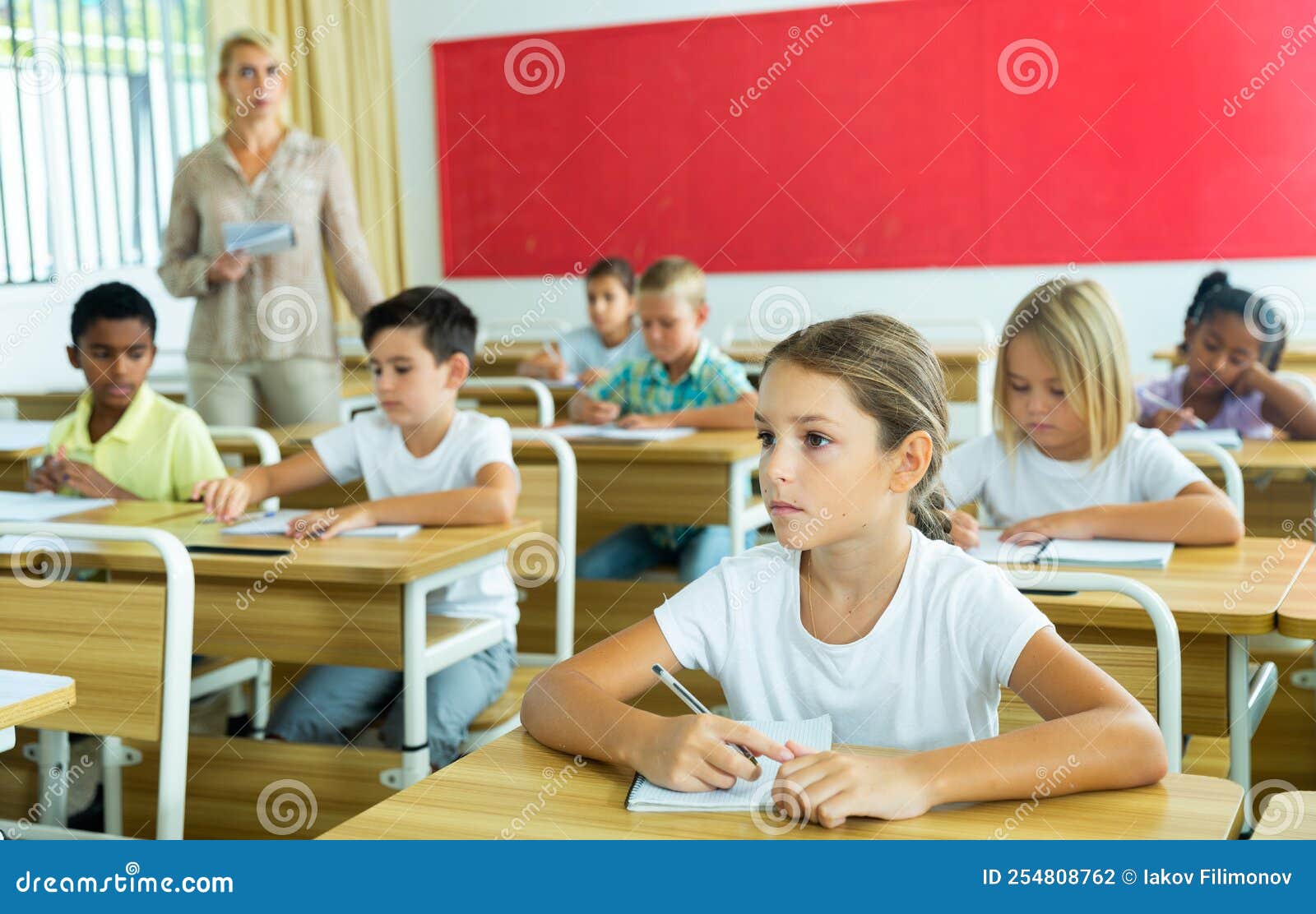 Young Girl is Sitting at the Desk in Classroom Elementary School Stock ... Young Girl is Sitting at the Desk in Classroom Elementary School Stock ...