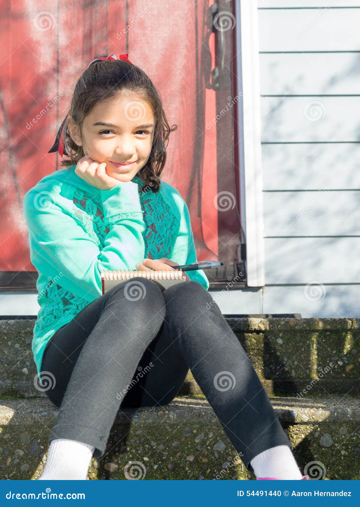 Young Girl Sitting Down Writing in Notepad Stock Photo - Image of girl ...