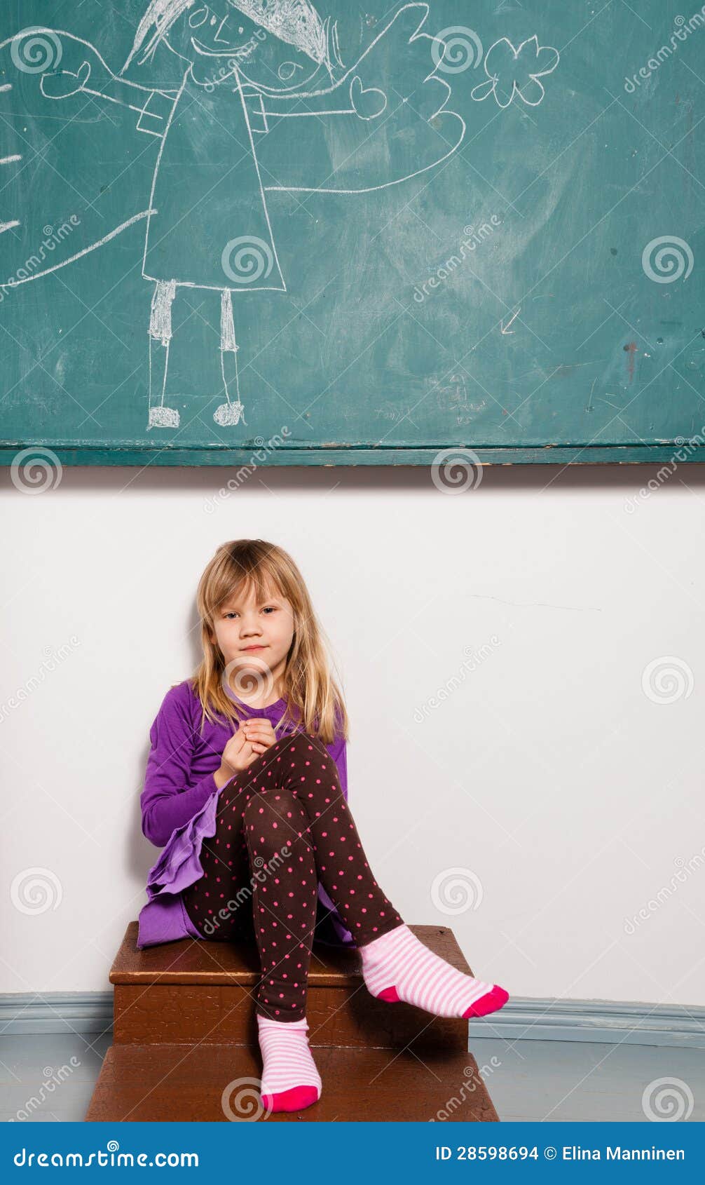 Young Girl Sitting in Front of Chalkboard Stock Photo - Image of blond ...