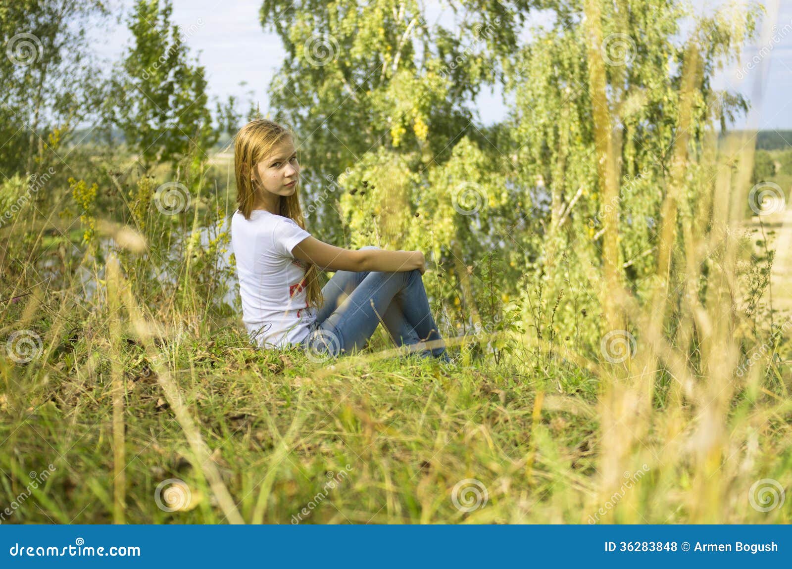 Young Girl Sitting in the Grass Stock Photo - Image of attractive ...