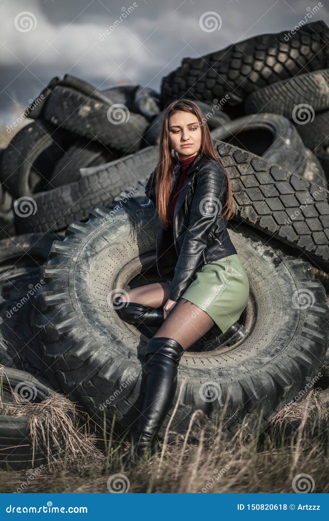 Girl sitting in the tyres stock photo. Image of apocalypse - 150820618