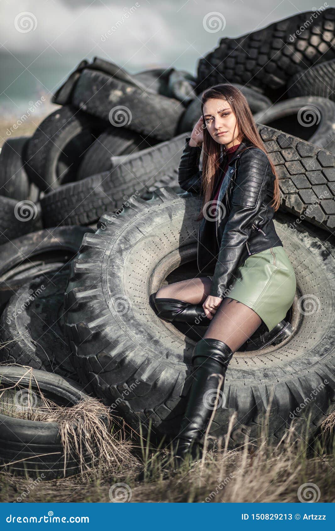 Girl sitting in the tyres stock image. Image of industry - 150829213