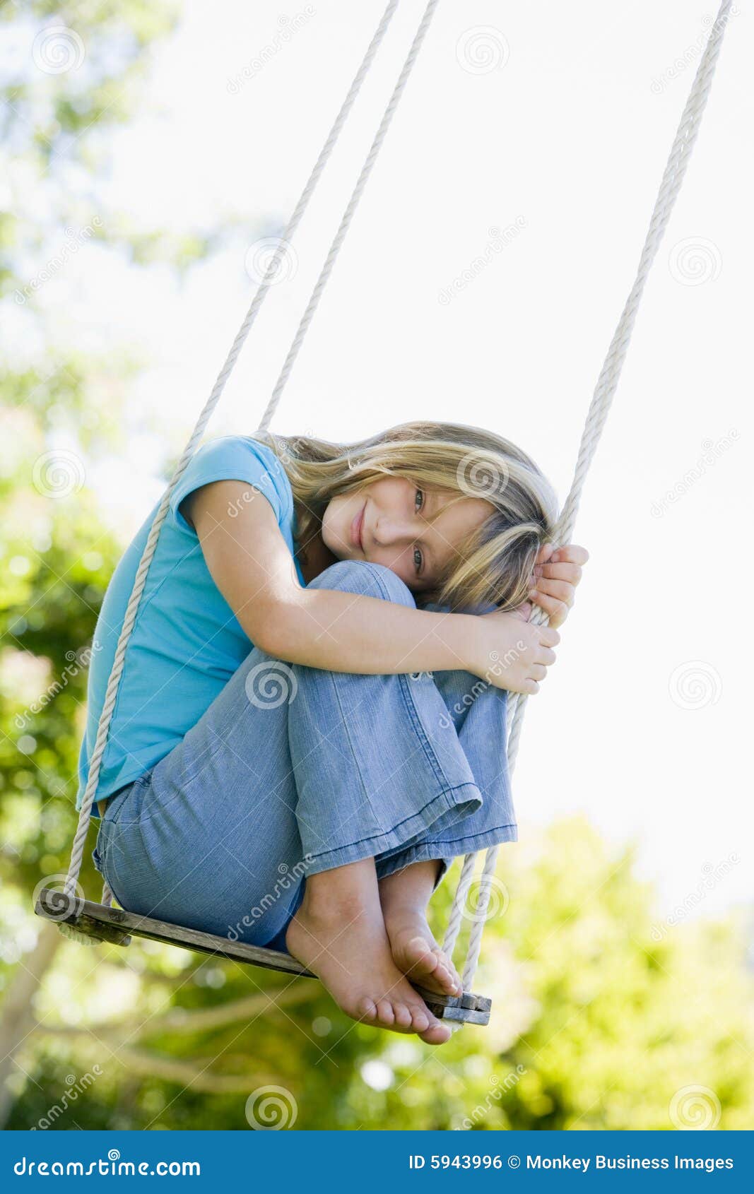 Young Girl Sitting on Swing Smiling Stock Photo - Image of outdoors ...