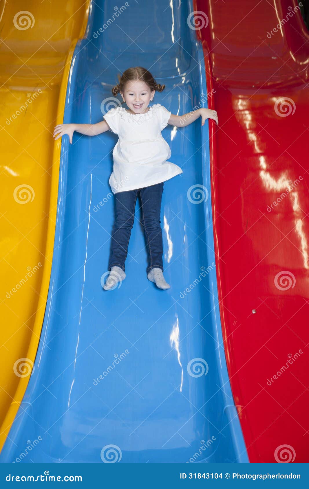 Young Girl Slides Down Colorful Slide Stock Photo - Image of happiness ...