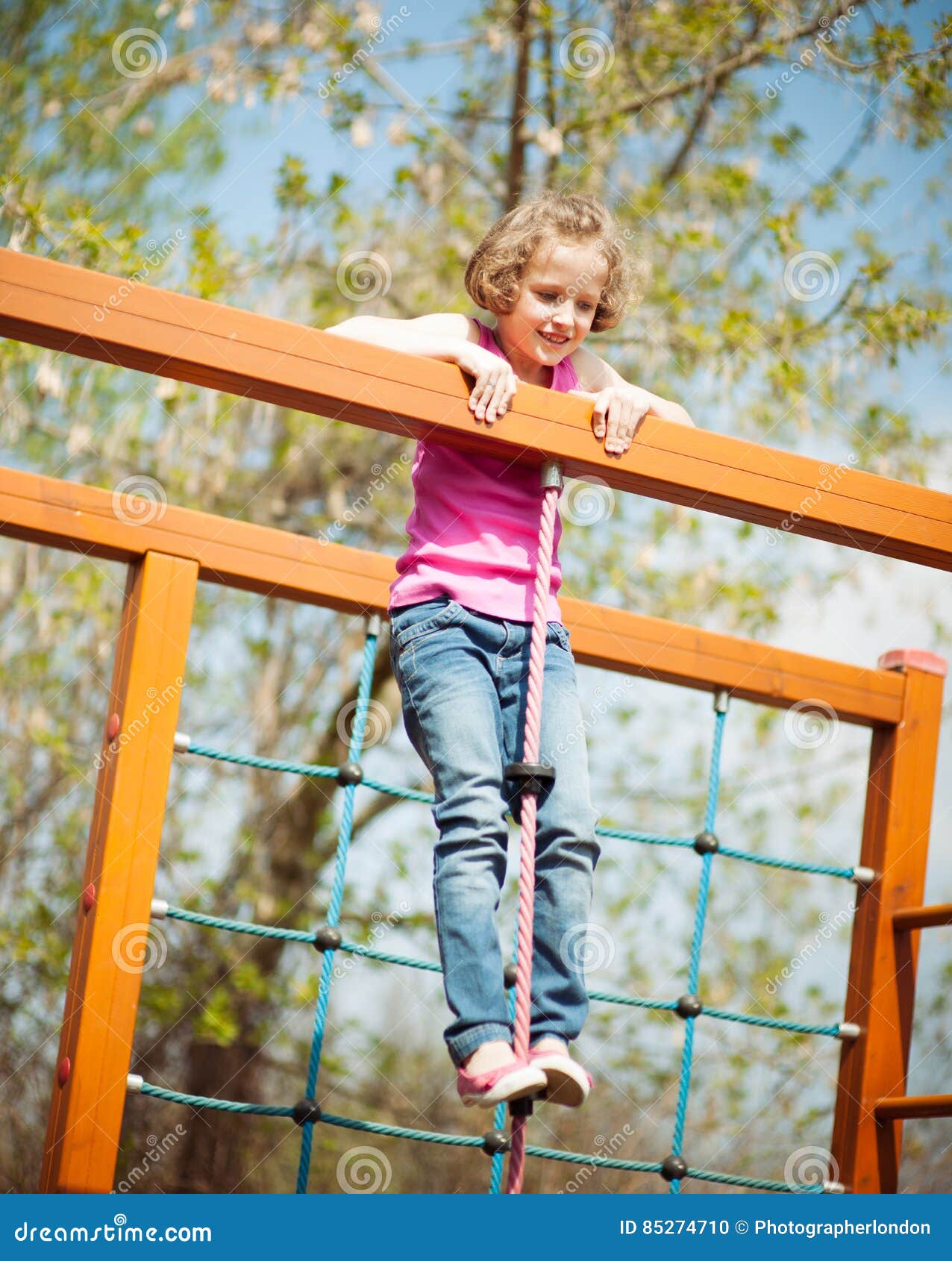 Young Girl Standing at Top of Rope and Climbing Frame Stock Photo ...