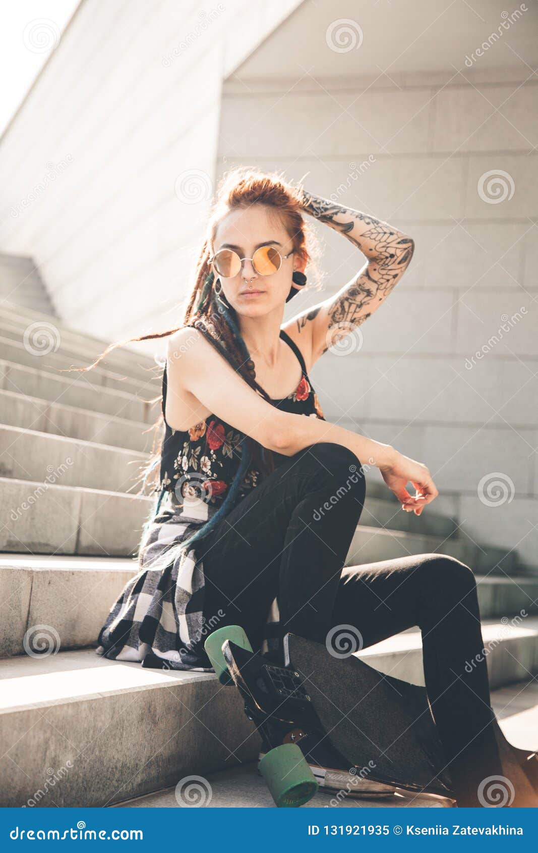 Young Girl With Tattoo And Dreadlocks Sitting On The Steps Stock Image