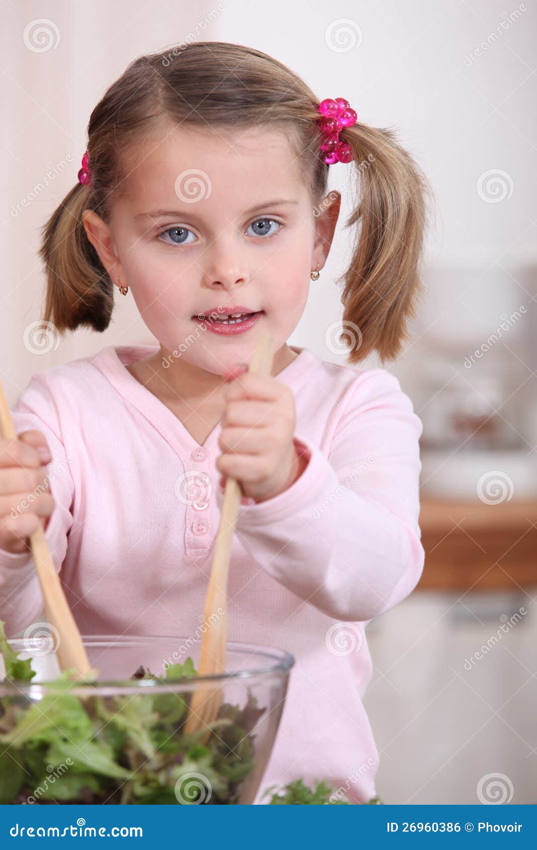Young girl tossing a salad stock photo. Image of pigtails - 26960386
