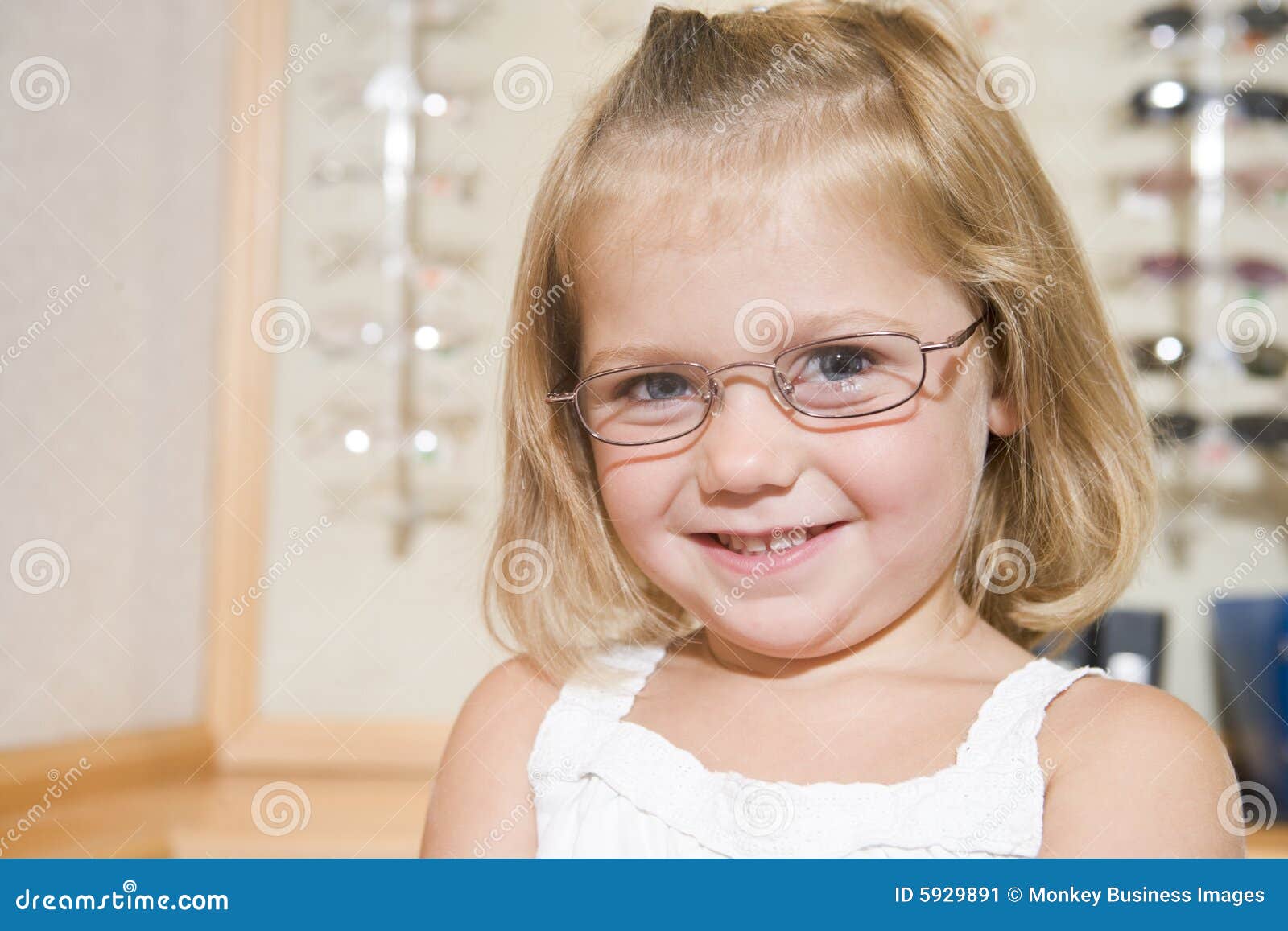 Young Girl Trying on Eyeglasses at Optometrists Stock Image - Image of ...