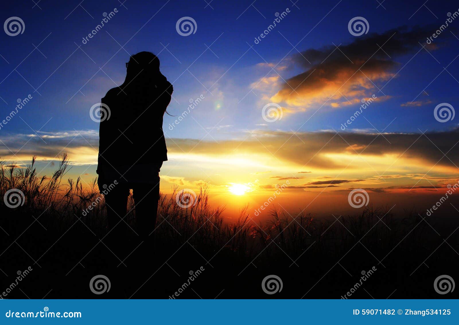 Young Girl Under the Setting Sun Stock Photo - Image of blue, sunset ...
