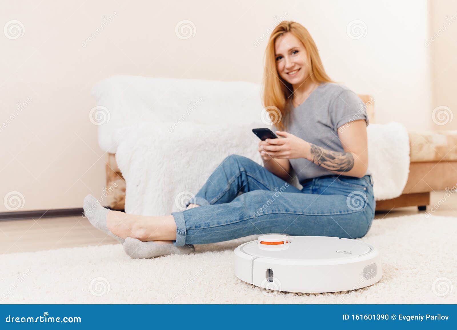 Young Girl Using Automatic Robot Vacuum Cleaner Working on Carpet ...