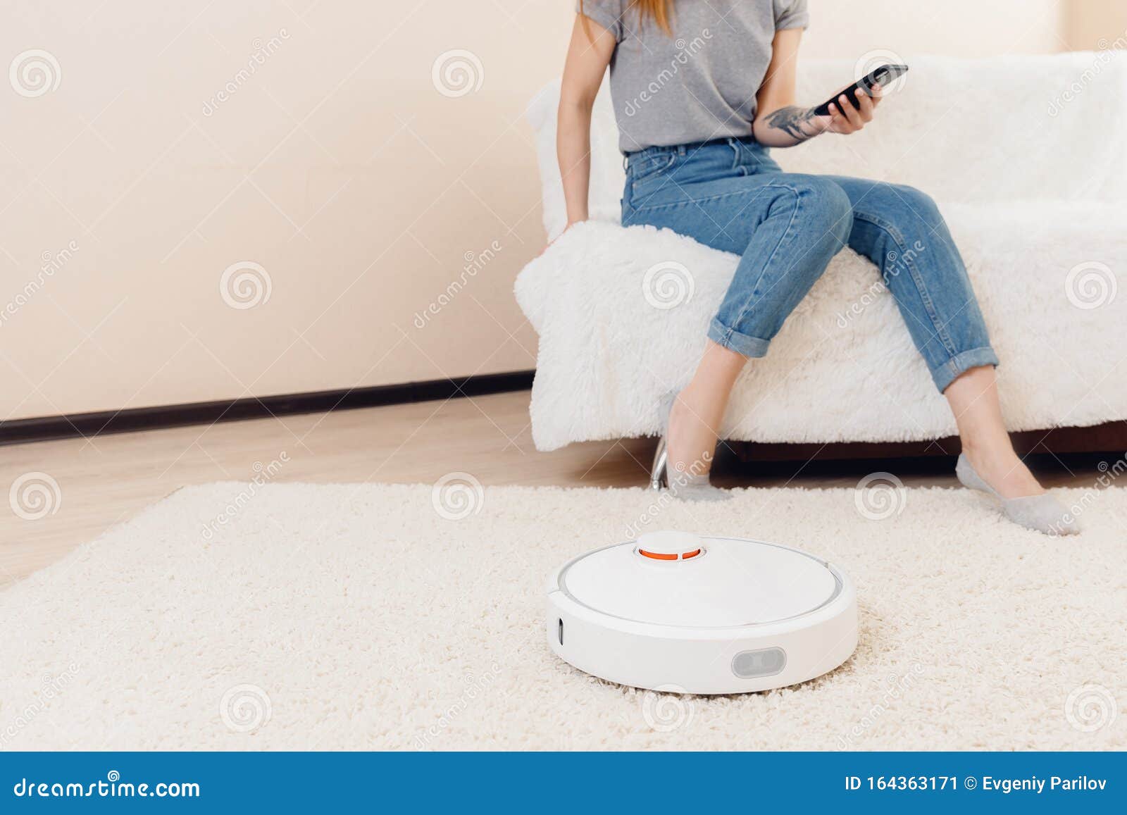 Young Girl Using Automatic Robot Vacuum Cleaner Working on Carpet ...