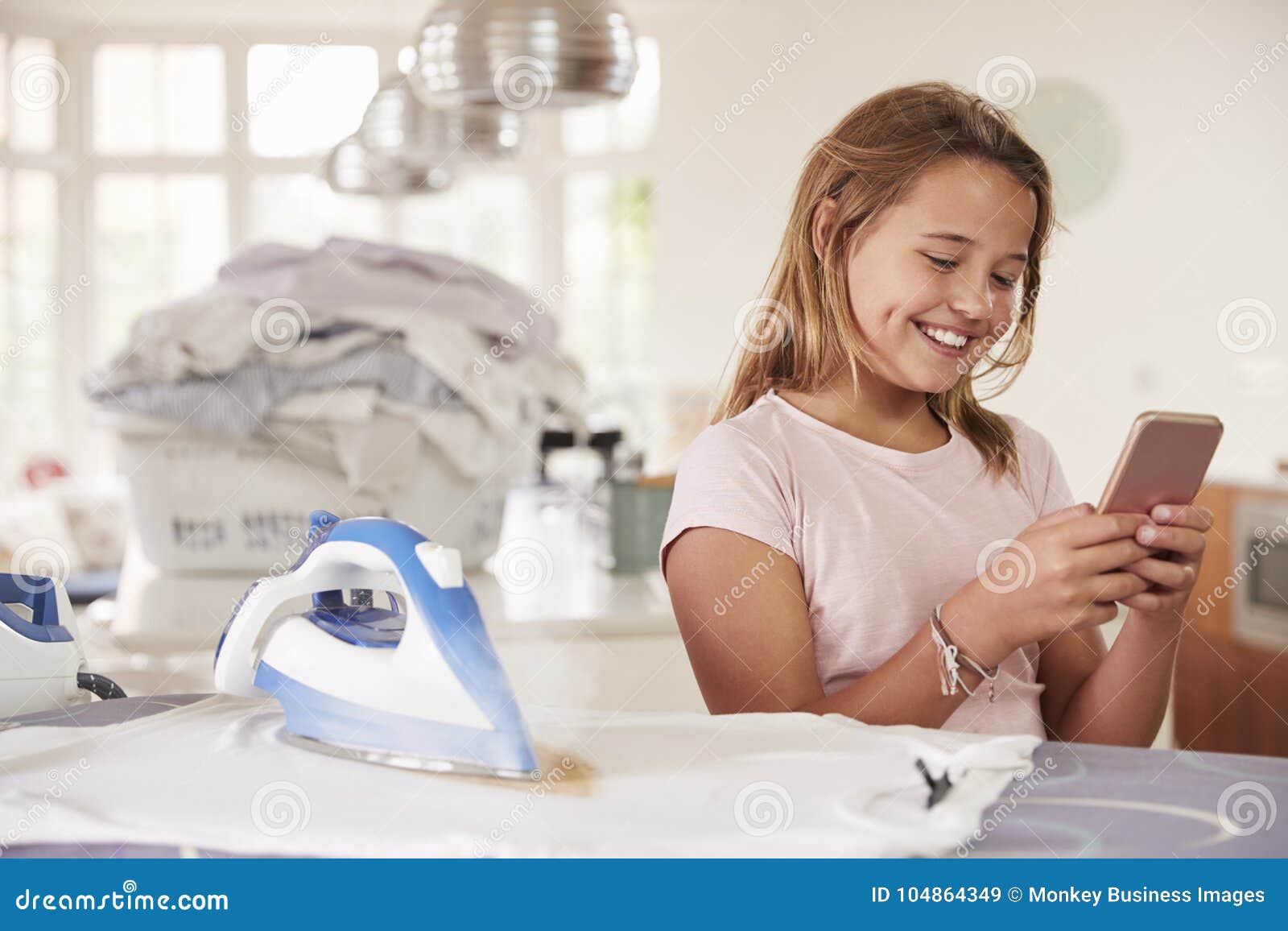 Young Girl Using Distracted by Phone while Ironing Stock Image - Image ...